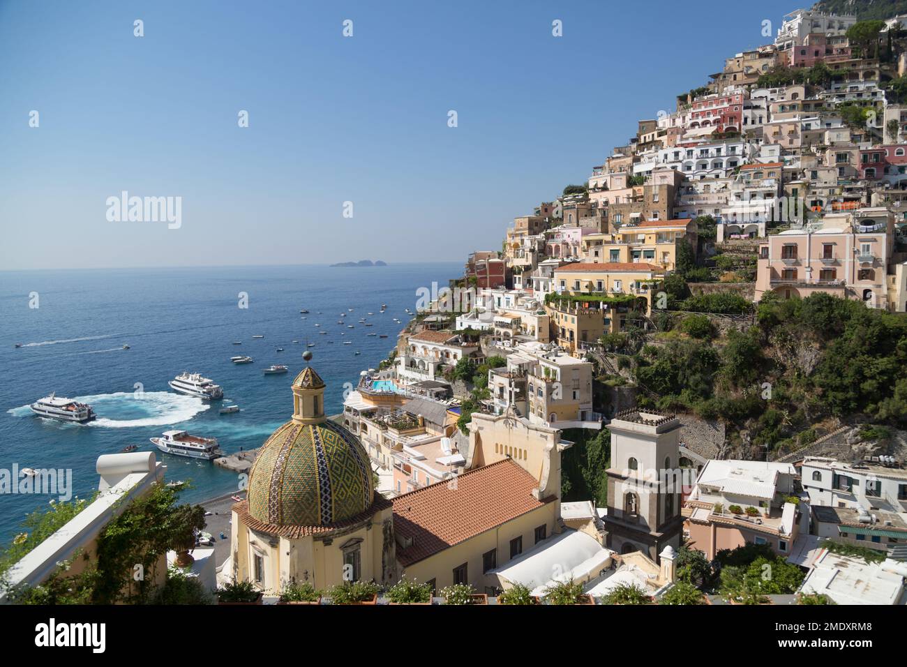 View of boats, buildings, beach and Tyrrhenian Sea in cliffside ...