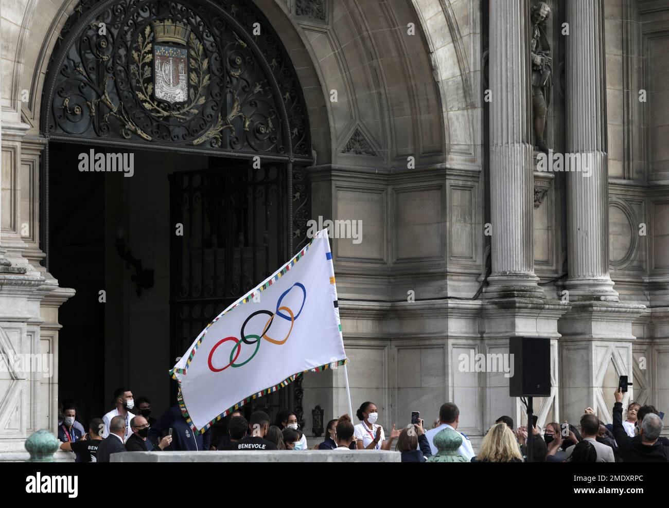 The Olympic flag is taken outside the Paris Town Hall, Monday, Aug.9 ...