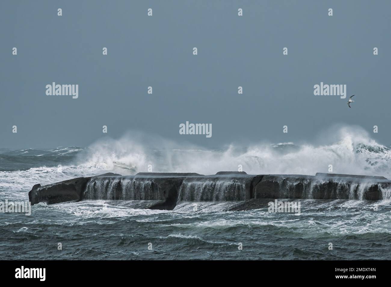 Storm surge creates high waves crashing on a jetty Stock Photo - Alamy