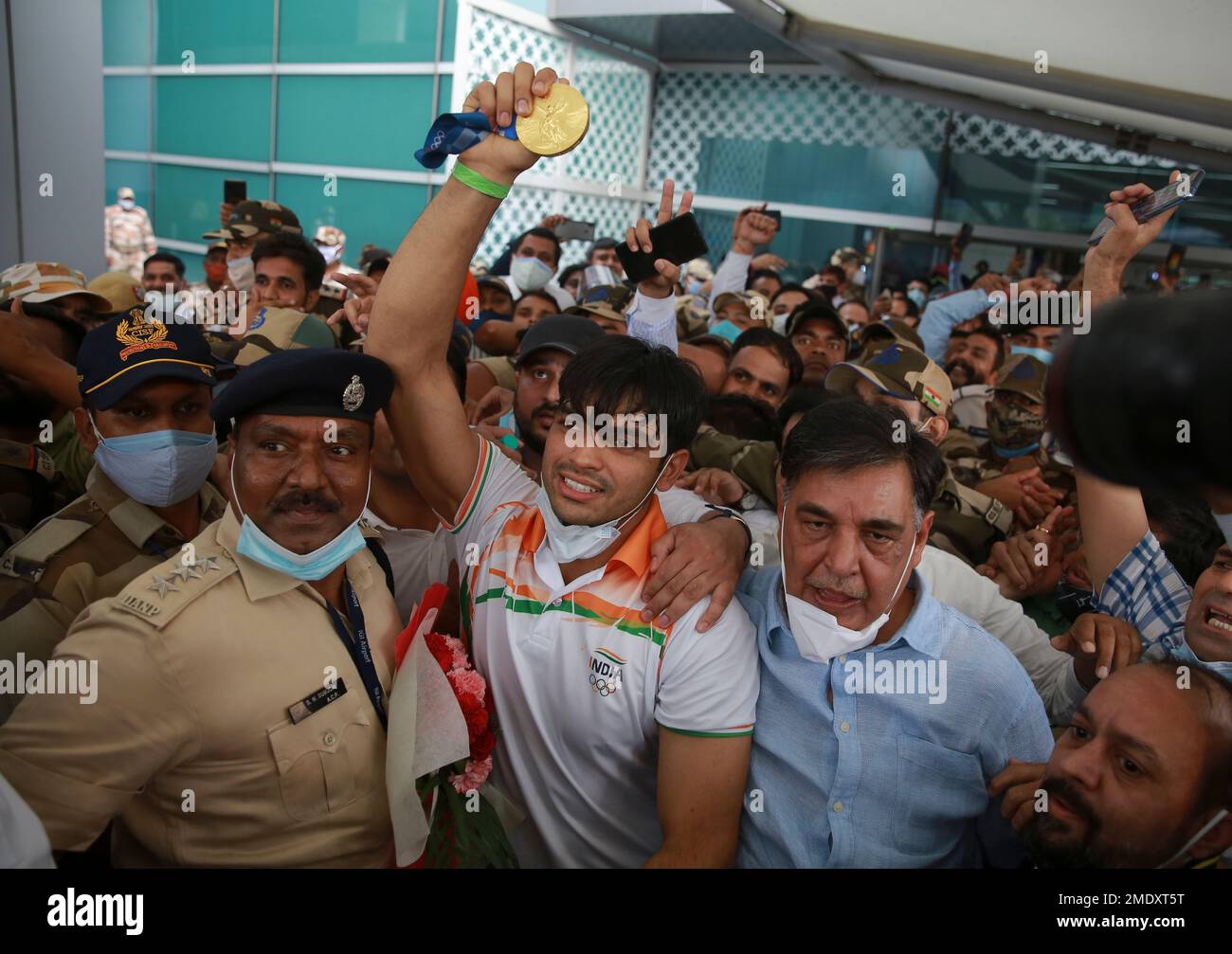 Olympic medallist Neeraj Chopra displays the gold medal he won in the ...