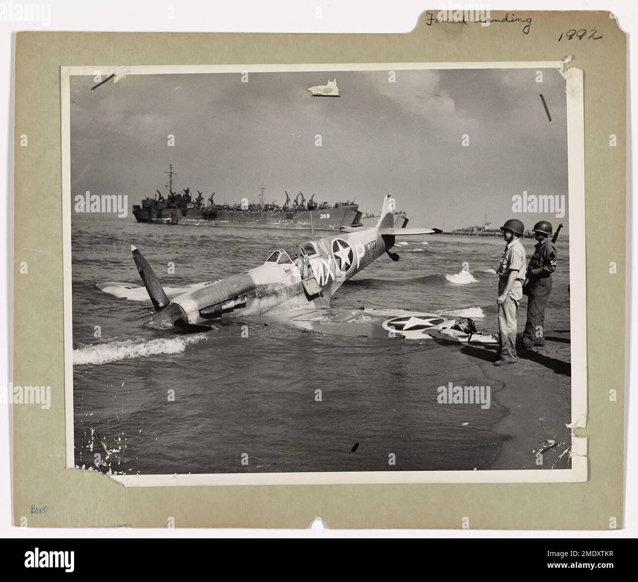 A Spitfire fighter plane is forced to land on the invasion beach at ...