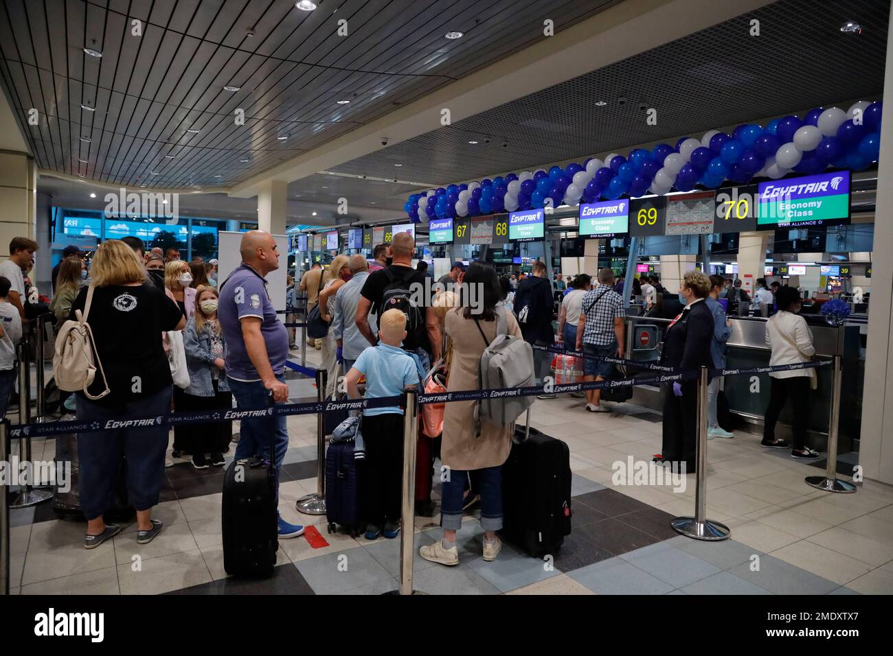 Russian tourists gather at the Egyptair check-in desk at the Domodedovo ...