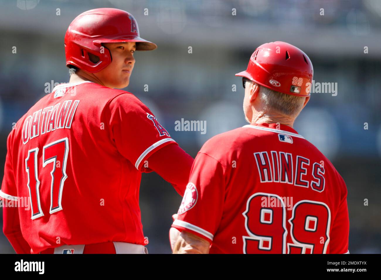 Los Angeles Angels' Shohei Ohtani, left, talks with first base coach ...