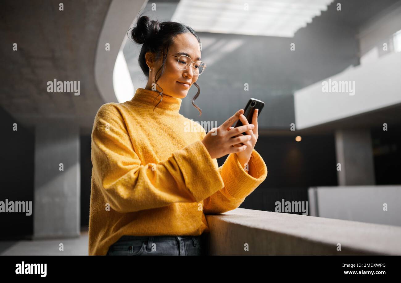 Woman, phone and texting in office building, thinking and calm while on ...