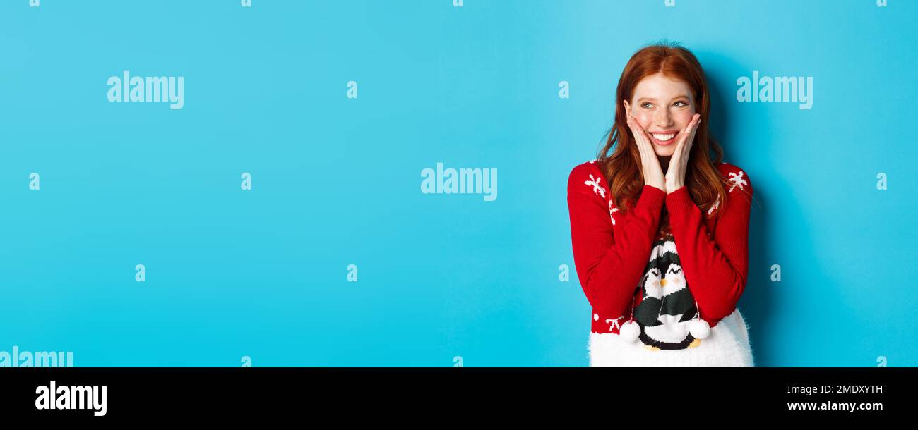 Winter holidays and Christmas Eve concept. Adorable redhead girl ...