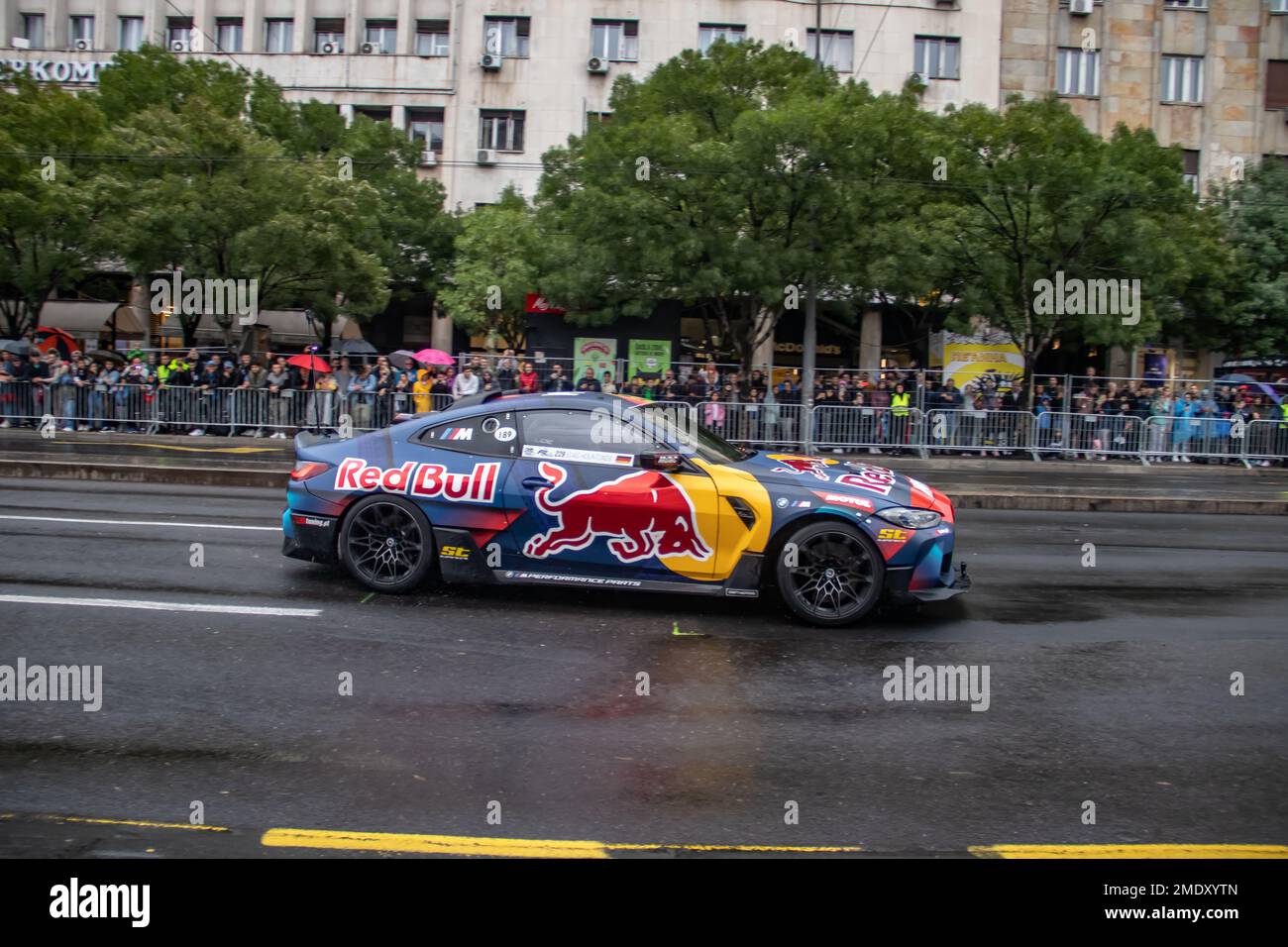 Racing red-bull sport vehicle on city streets, driven by Elias ...