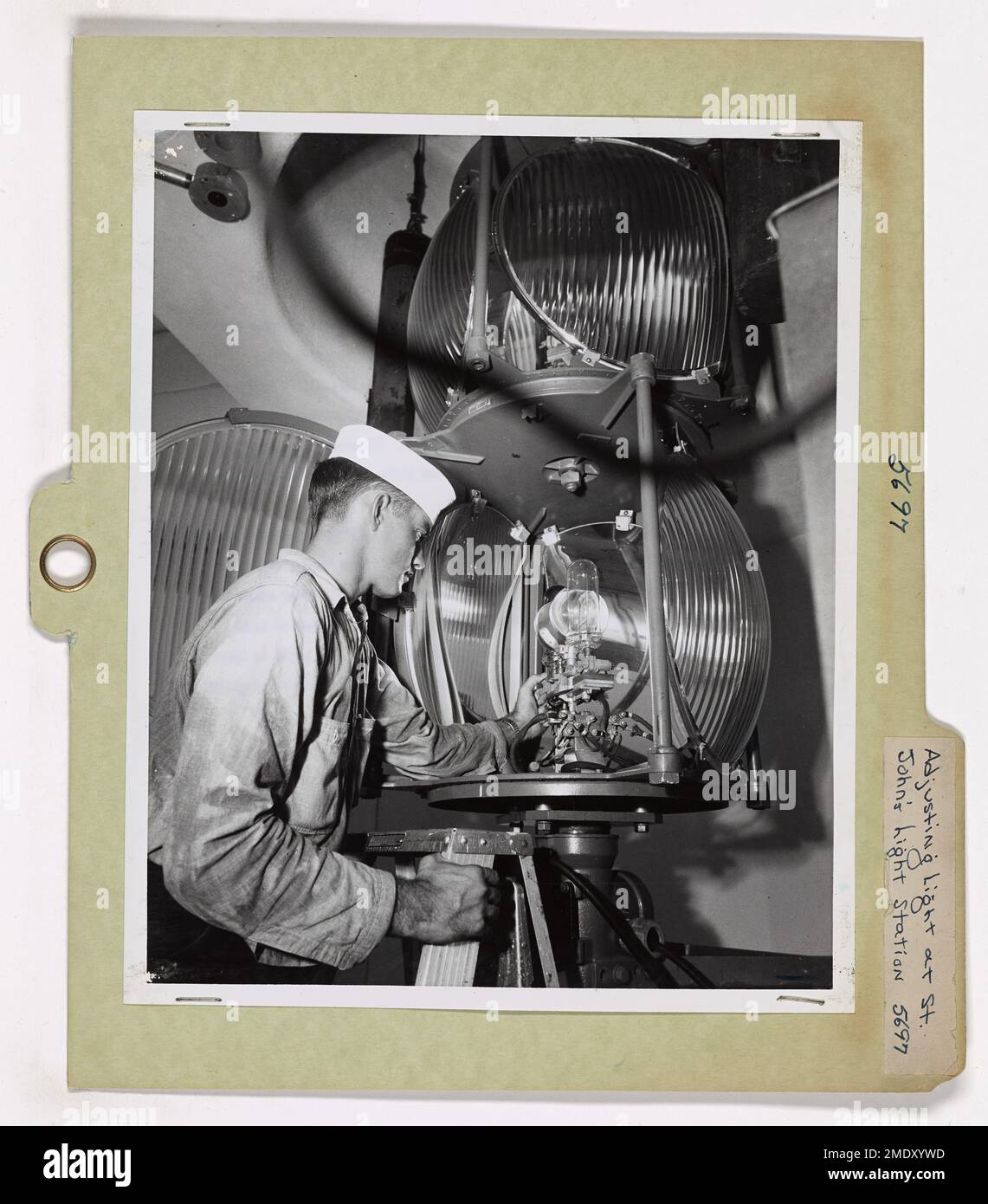 A Coast Guardsman adjusts the light at St. John's Light Station in ...