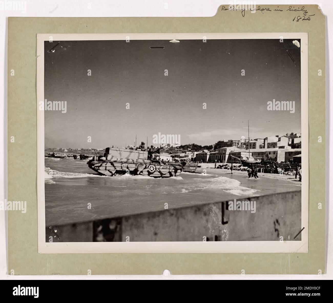 This image captures U.S. amphibious duck trucks landing on the shores ...