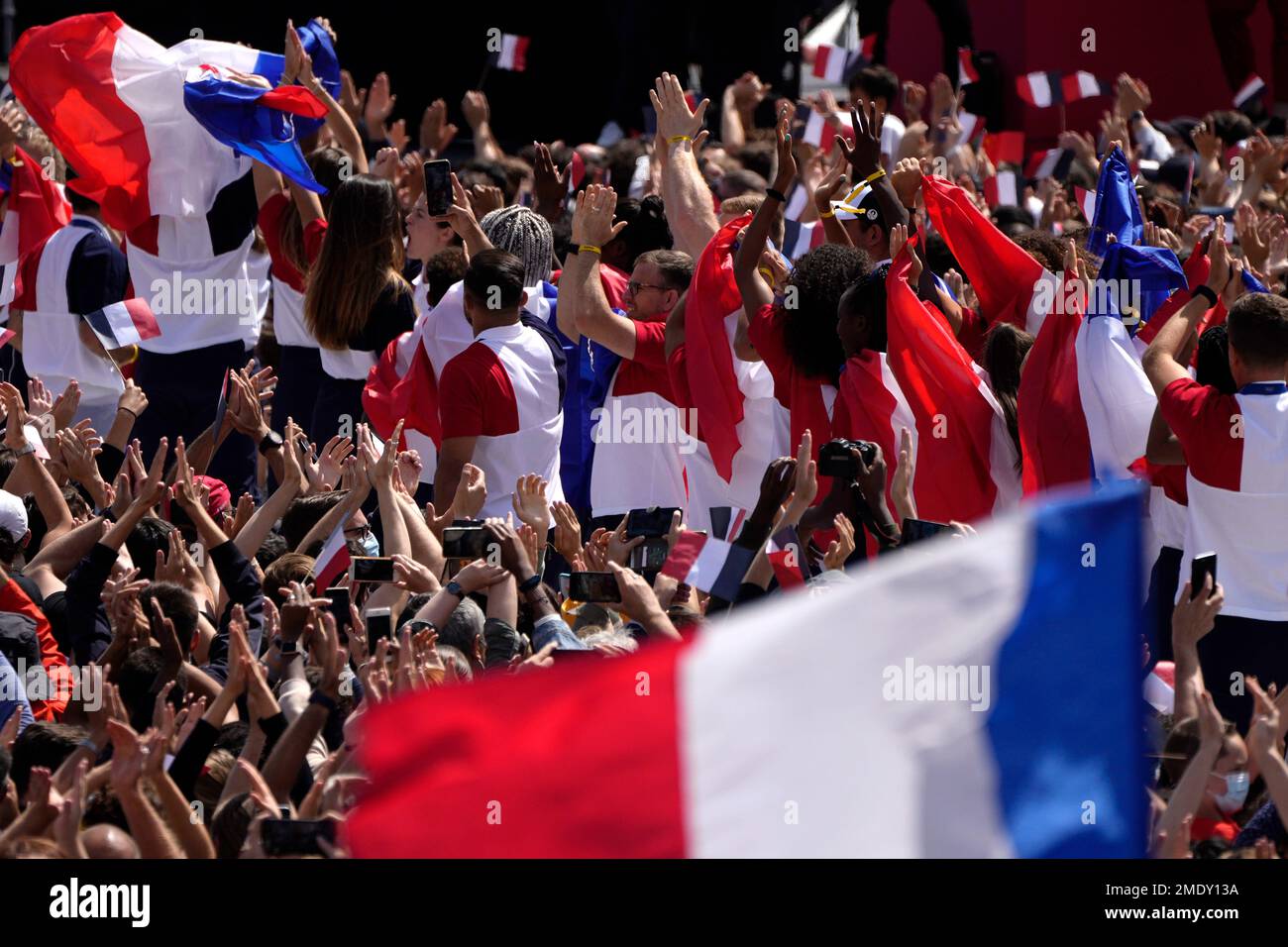 Fans wave French flags and cheer in the Olympics fan zone at Trocadero ...