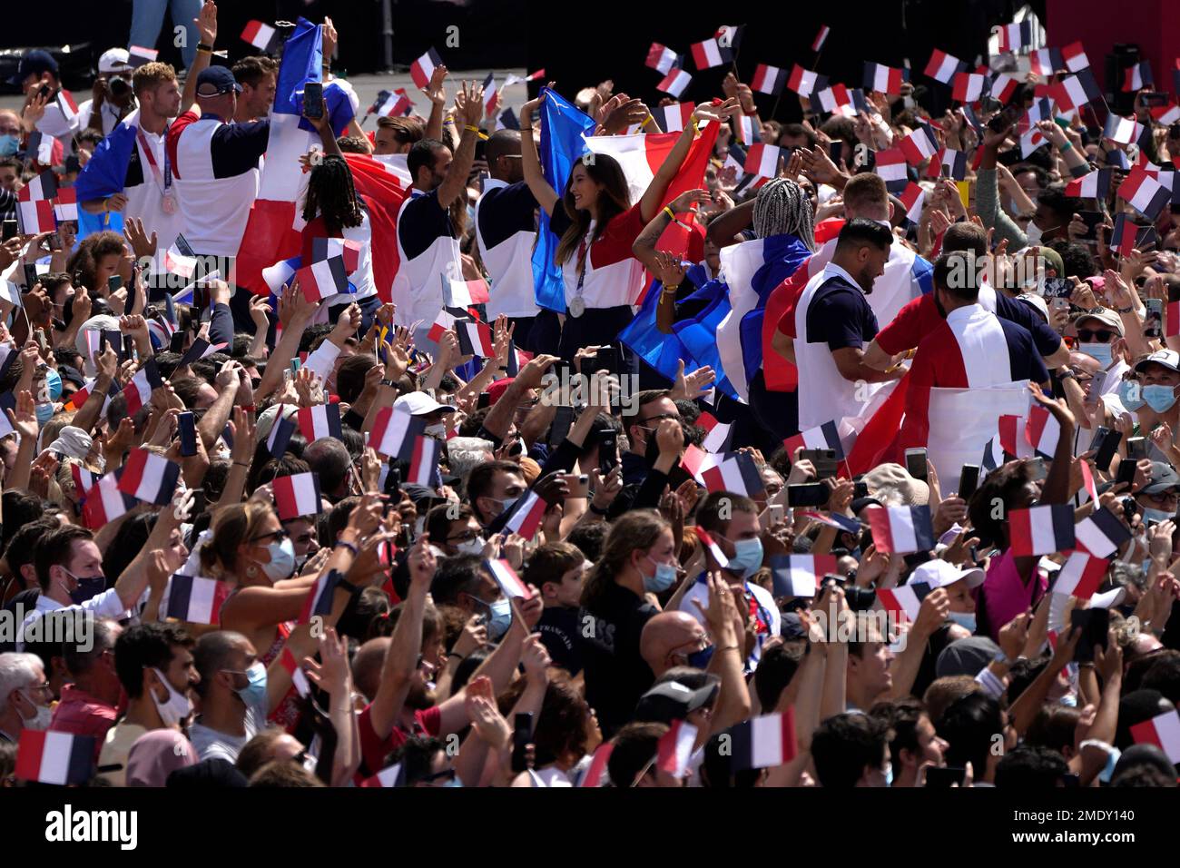 Fans wave French flags and cheer in the Olympics fan zone at Trocadero ...