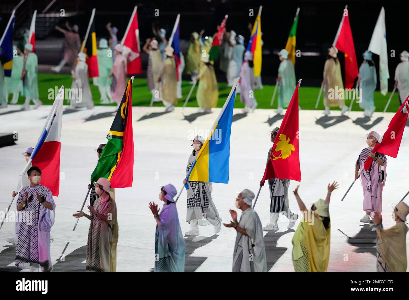 Athletes and volunteers carry flags during the closing ceremony in the ...