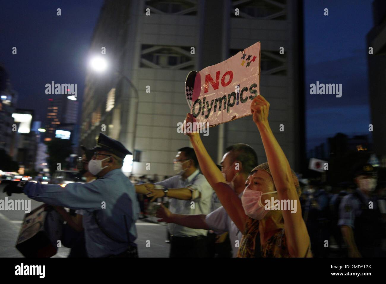 Anti-Olympic protesters are blocked by police officers in front of the ...