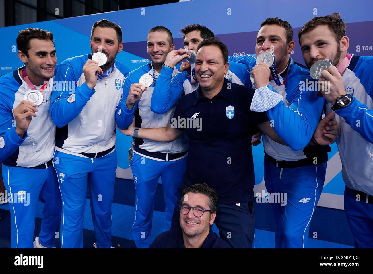 Greece's men's water polo team head coach Theodoros Vlachos, top center ...