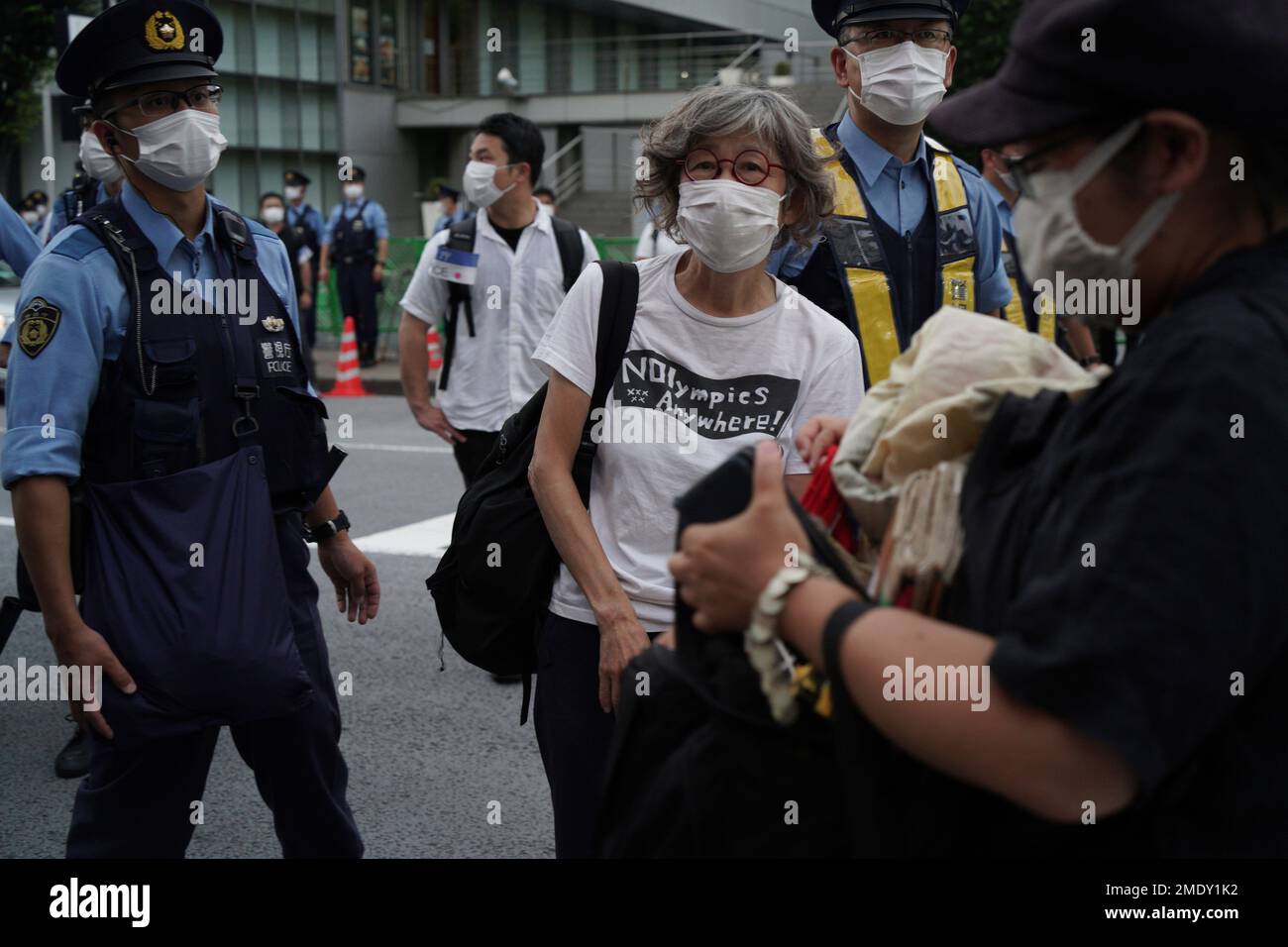 Anti-Olympic protestors are blocked by police officers in front of the ...