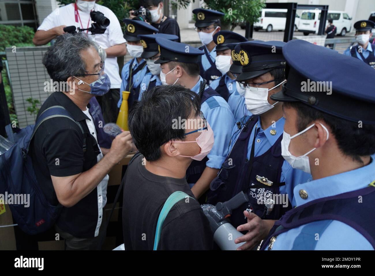 Anti-Olympic protestors are blocked by police officers in front of the ...