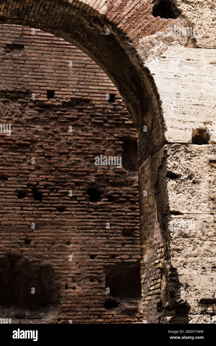 Large stone and brick arch against an old brick wall in Colosseum ...