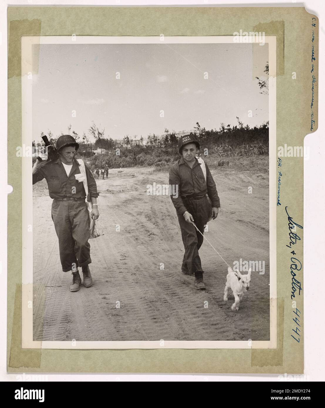 Coast Guardsmen Larison M. Sater, a combat photographer, and Clint ...