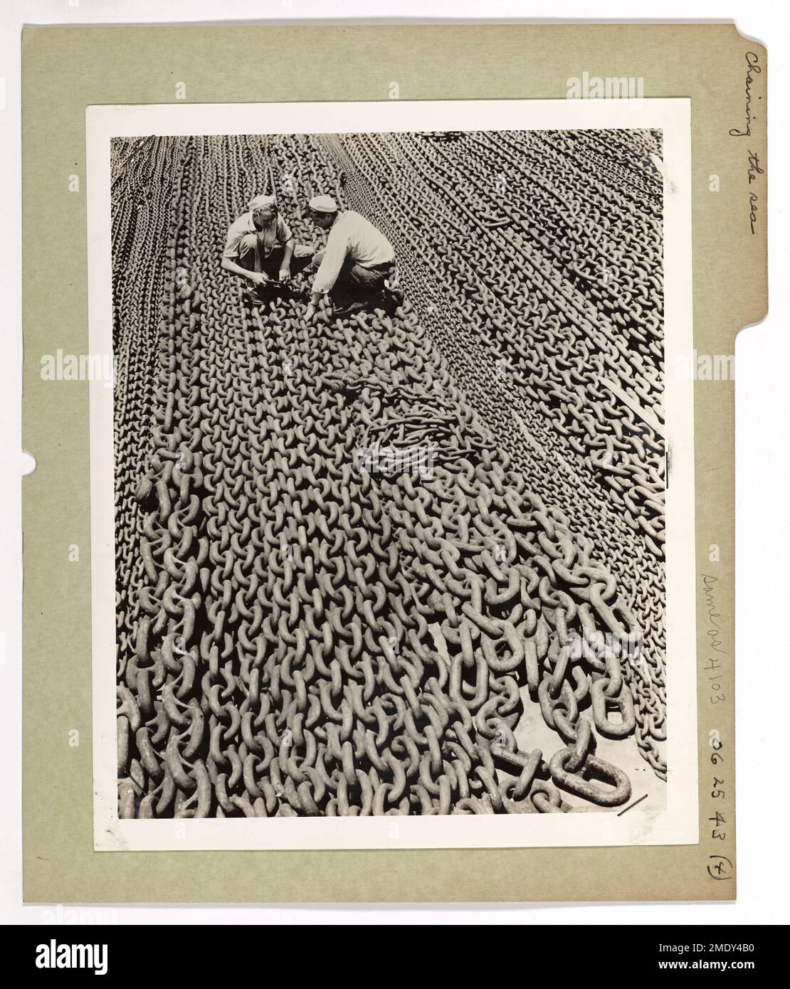 Coast Guardsmen work on a buoy and lightship chain at the Coast Guard ...