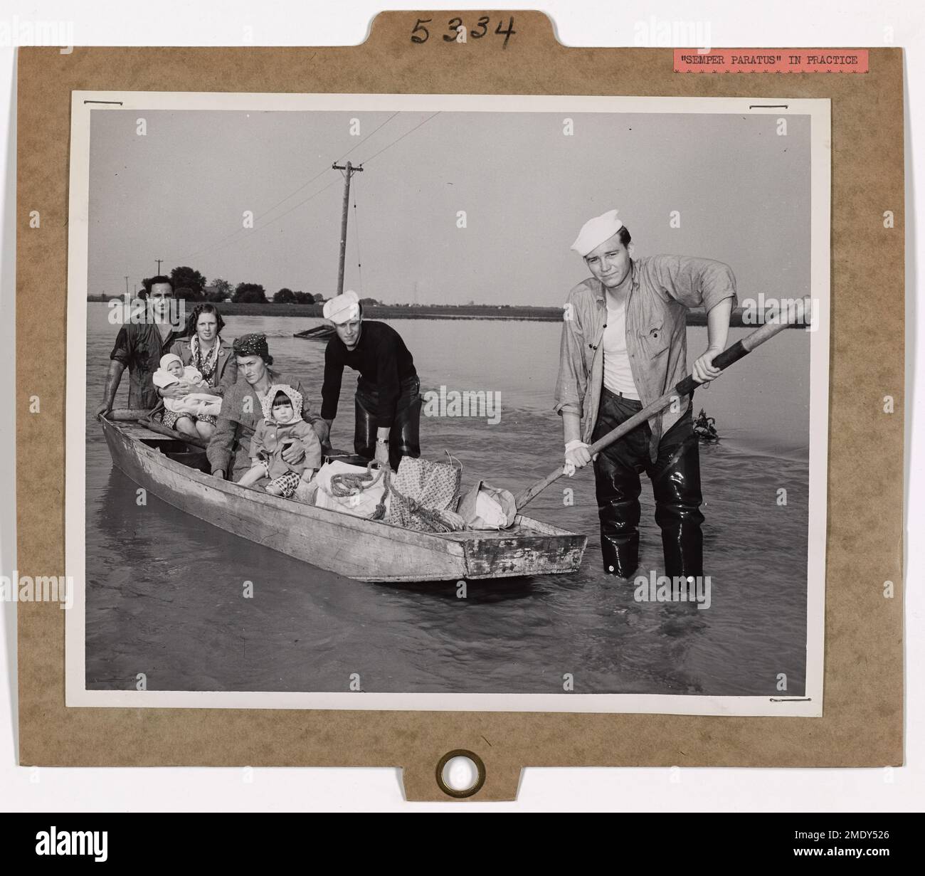 This image shows a Coast Guard rescue operation, with a family being ...