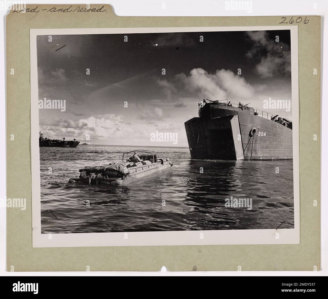 A 'duck' amphibious vehicle returns to a Coast Guard-manned LST to load ...