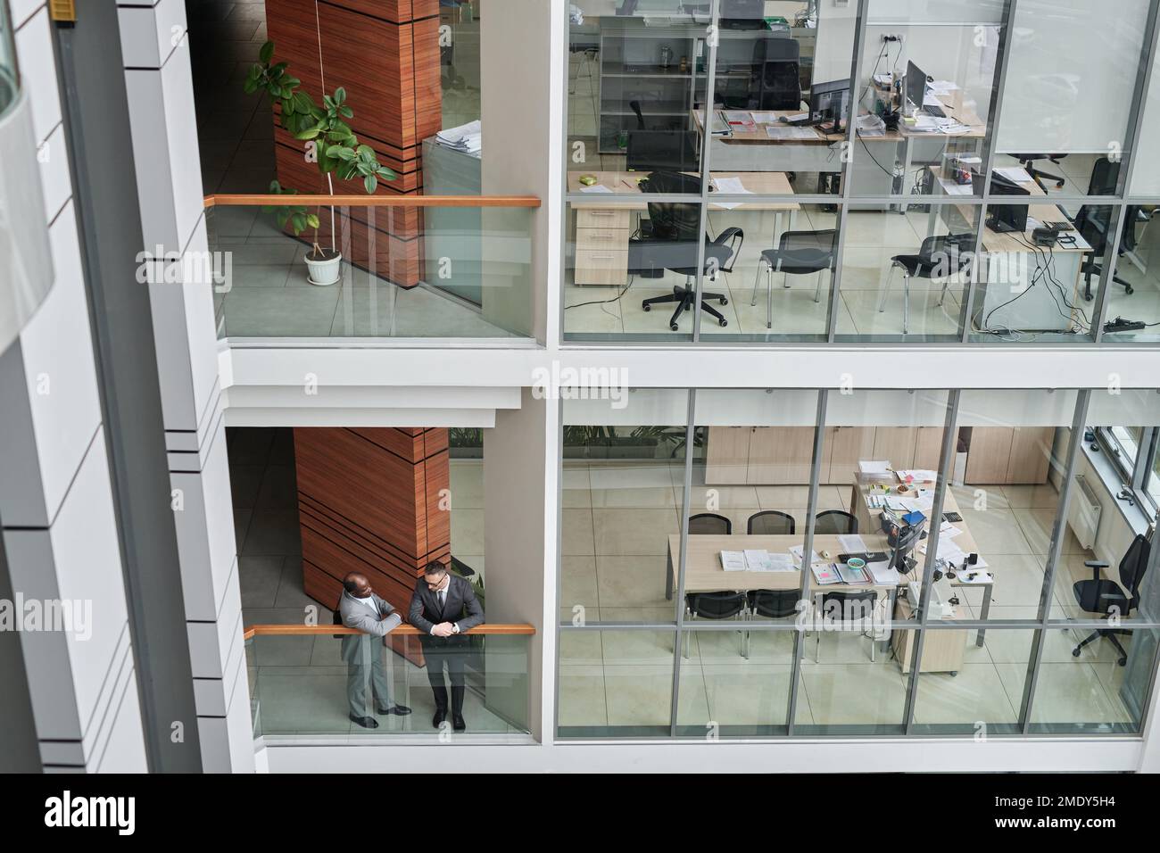 Two storeys of large business center with openspace offices behind huge ...