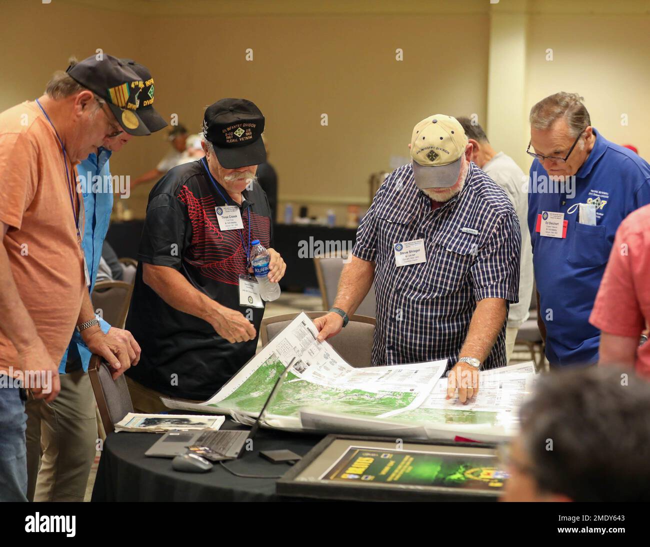 4th Infantry Division Vietnam veterans gather around a map of a ...