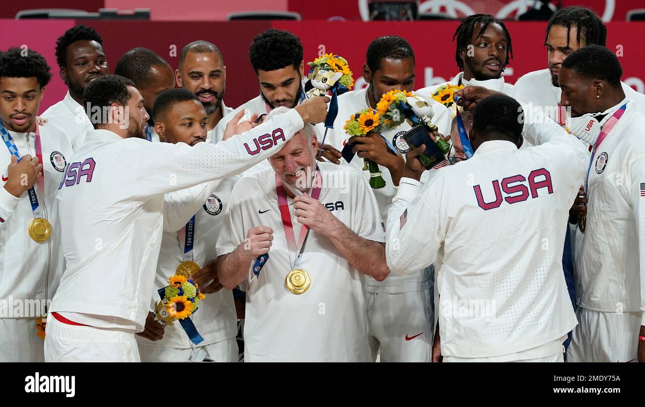 U.S. players put a gold medal on head coach Gregg Popovich during the ...