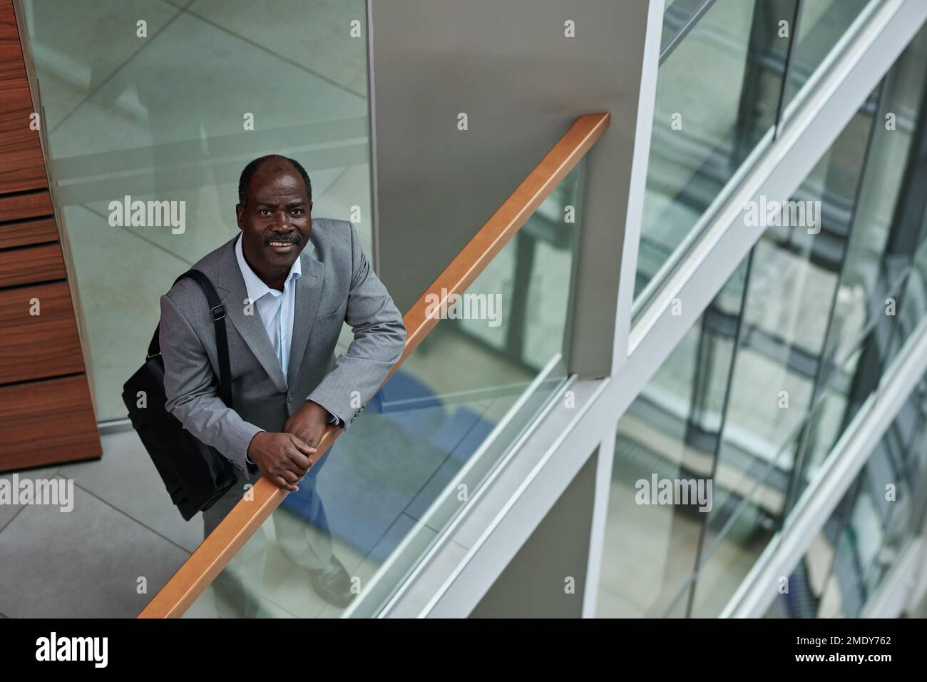 Mature African American businessman in grey suit looking at camera with ...