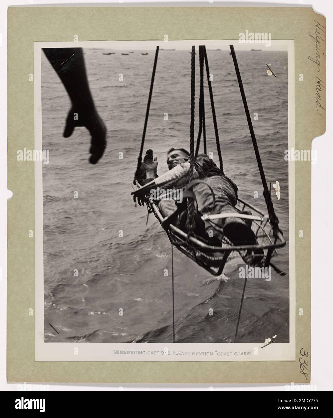 A wounded Marine is hoisted from a landing craft onto an assault ...