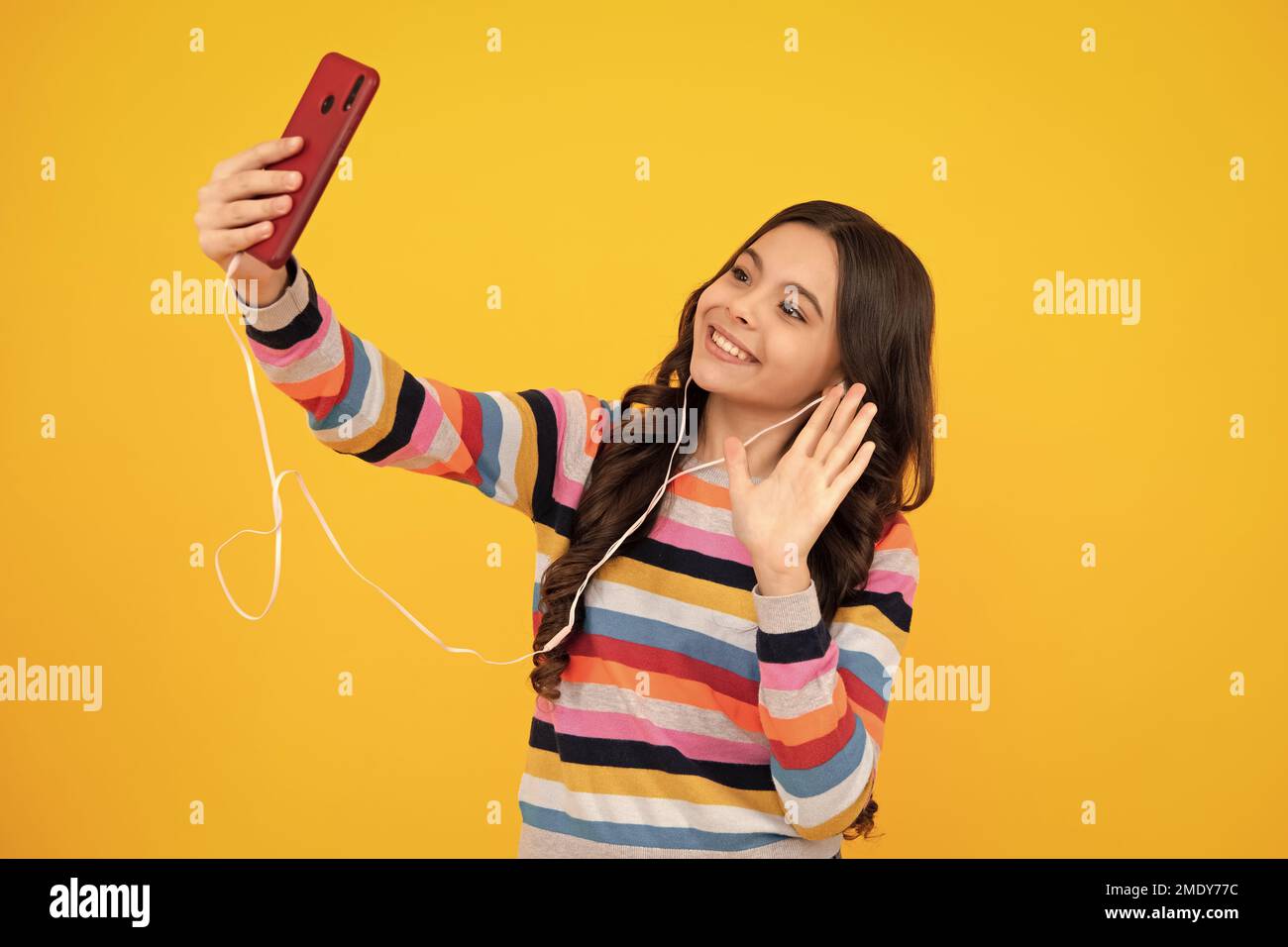 Kids selfie. Portrait of cute teenage girl using mobile phone, chatting ...