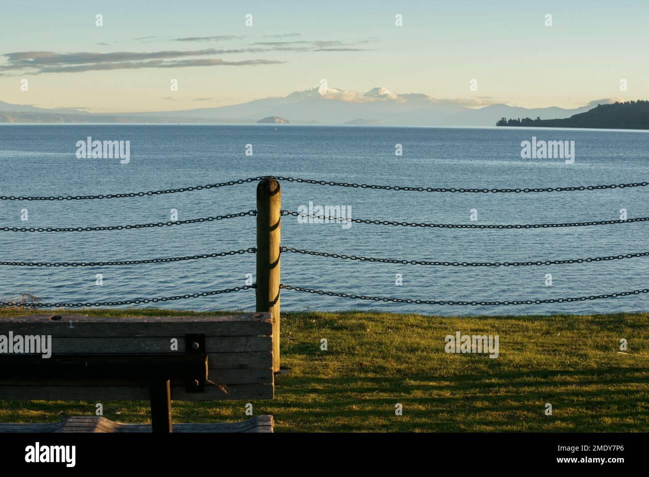 View across Lake Taupo with snow-capped mountains of Tongariro National ...