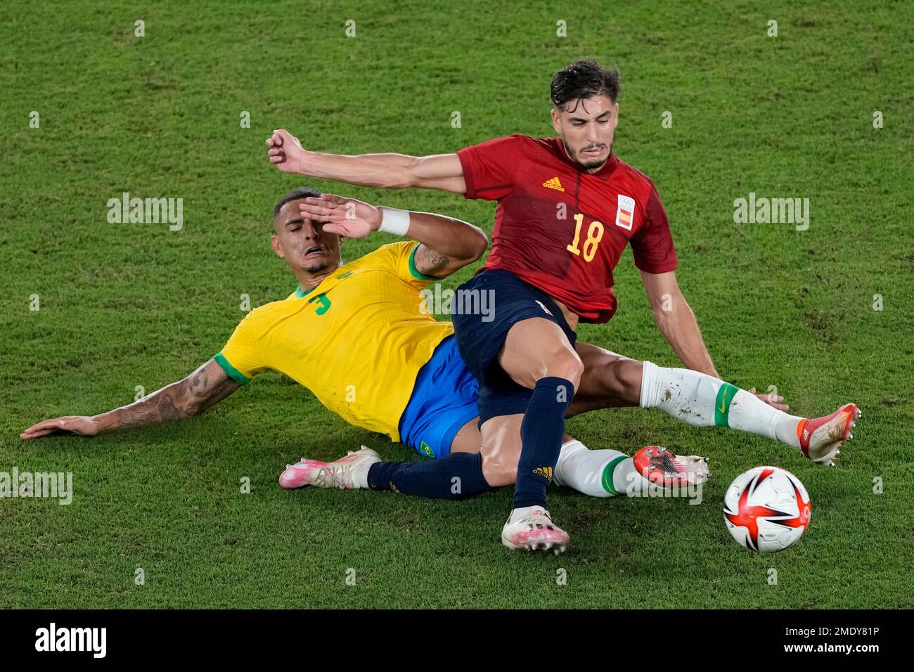 Brazil's Carlos Diego and Spain's Oscar Gil (18) battle for the ball in ...