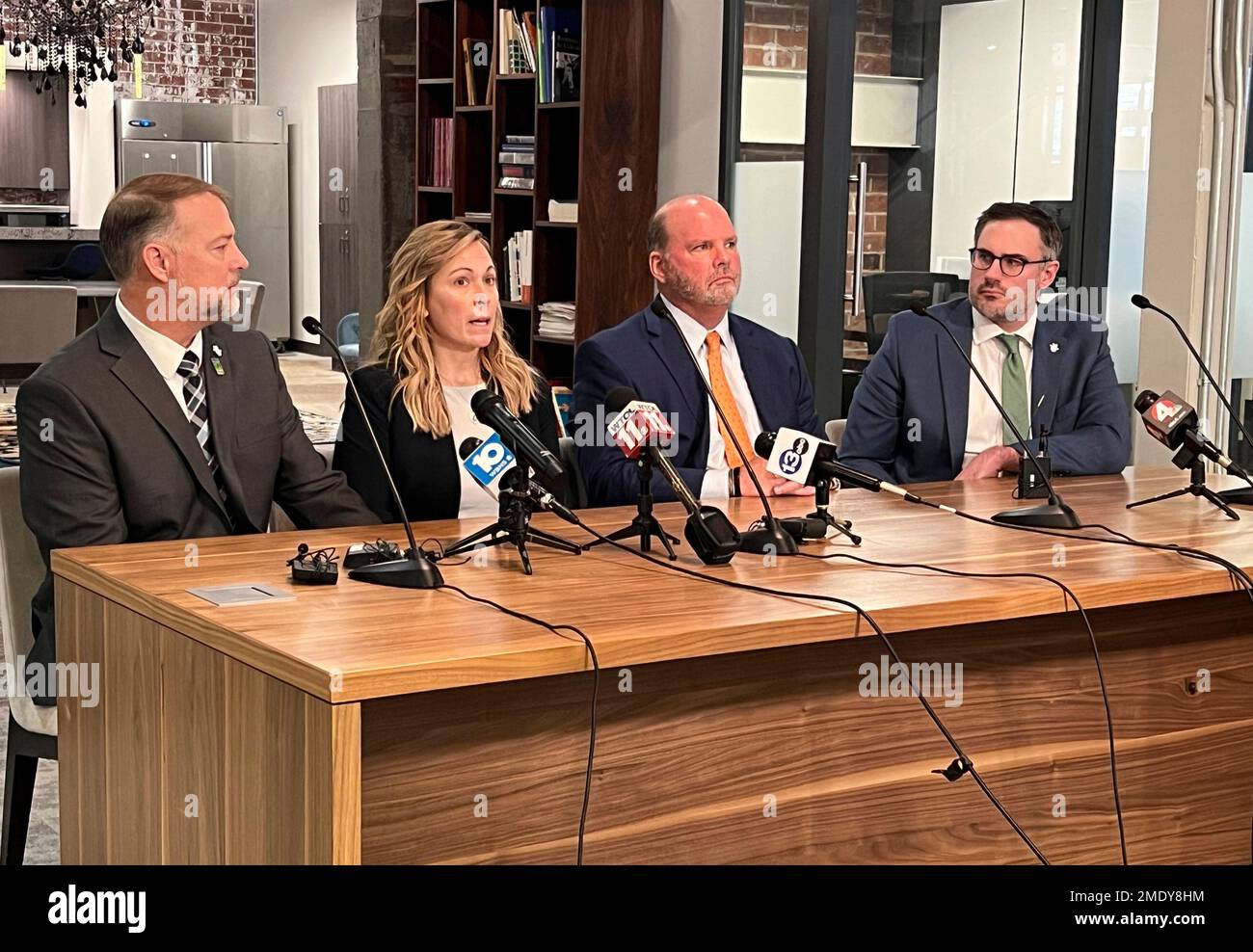 Shari Foltz, second left, speaks while her husband Cory Foltz, left ...
