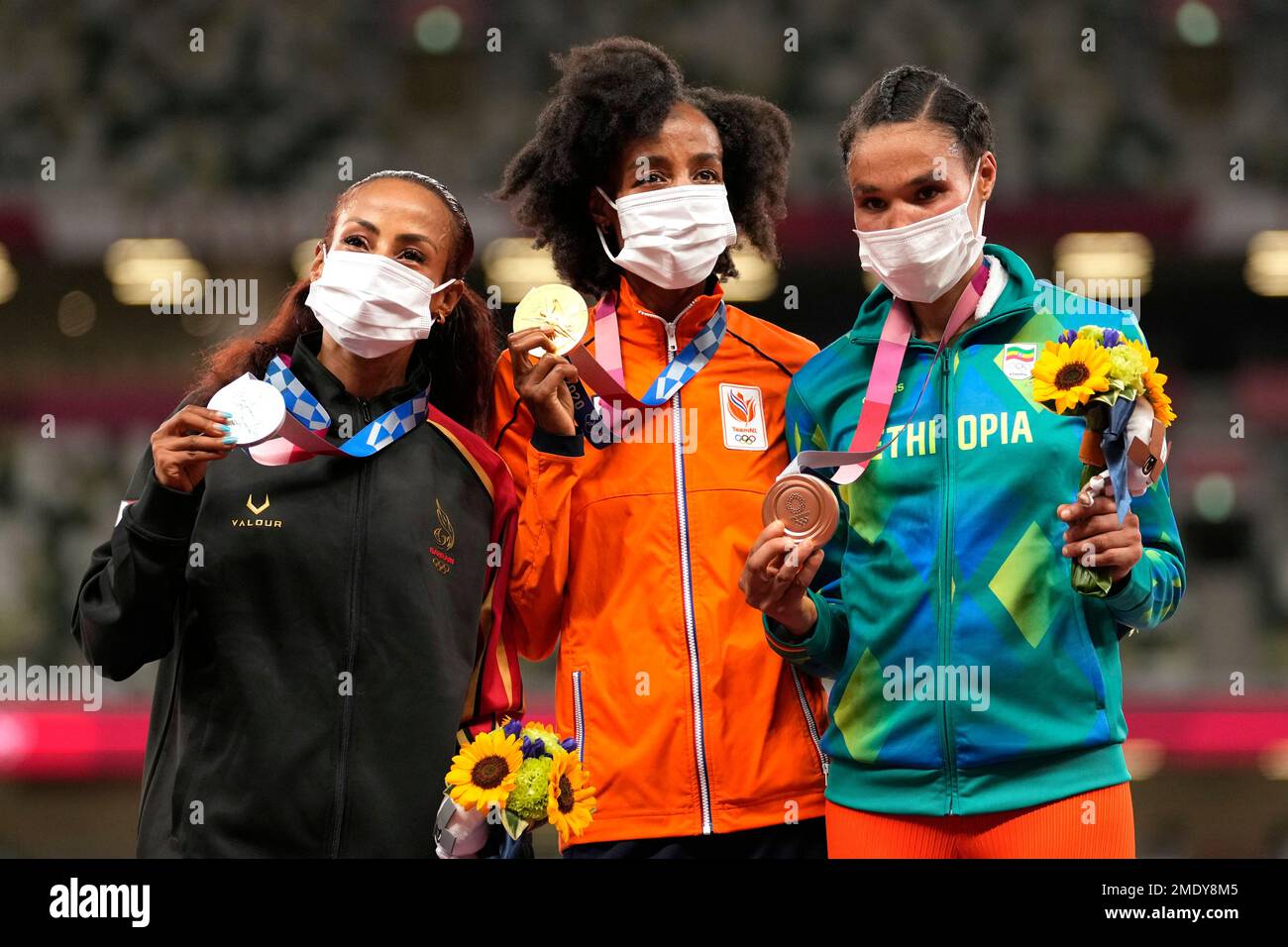 Gold medalist Sifan Hassan, of Netherlands, center, stands with silver medalist Kalkidan ...