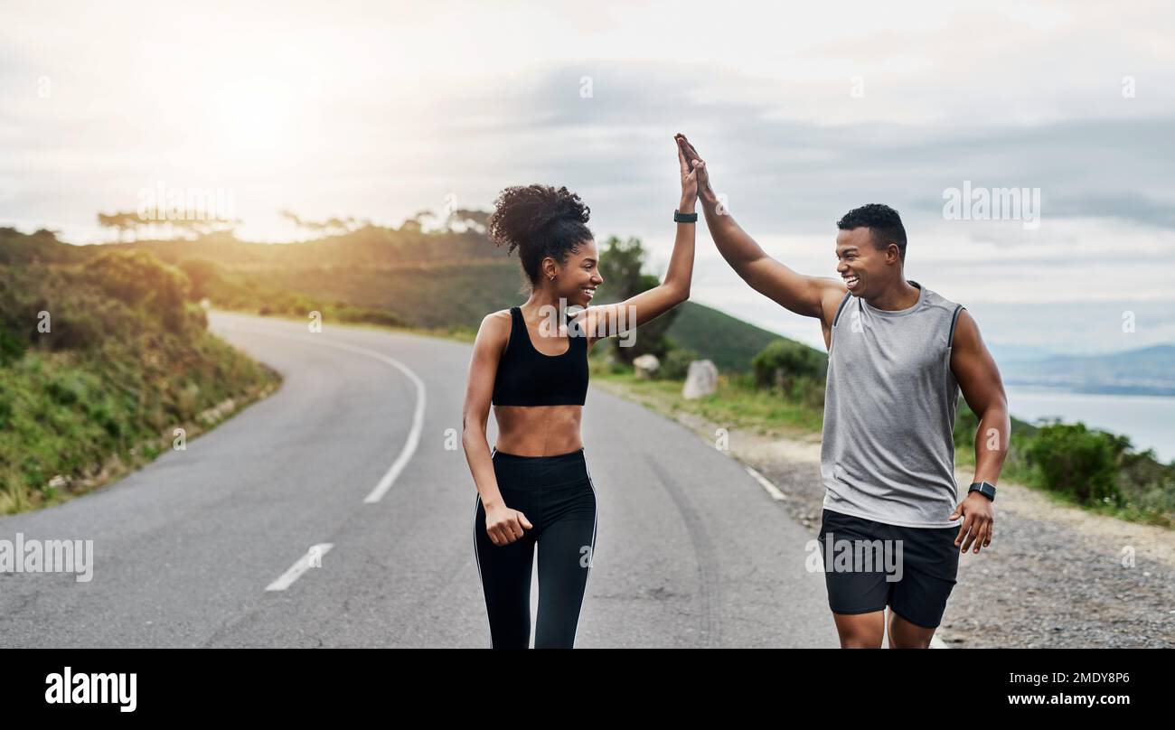 We smashed our goals. a sporty young couple high fiving each other ...