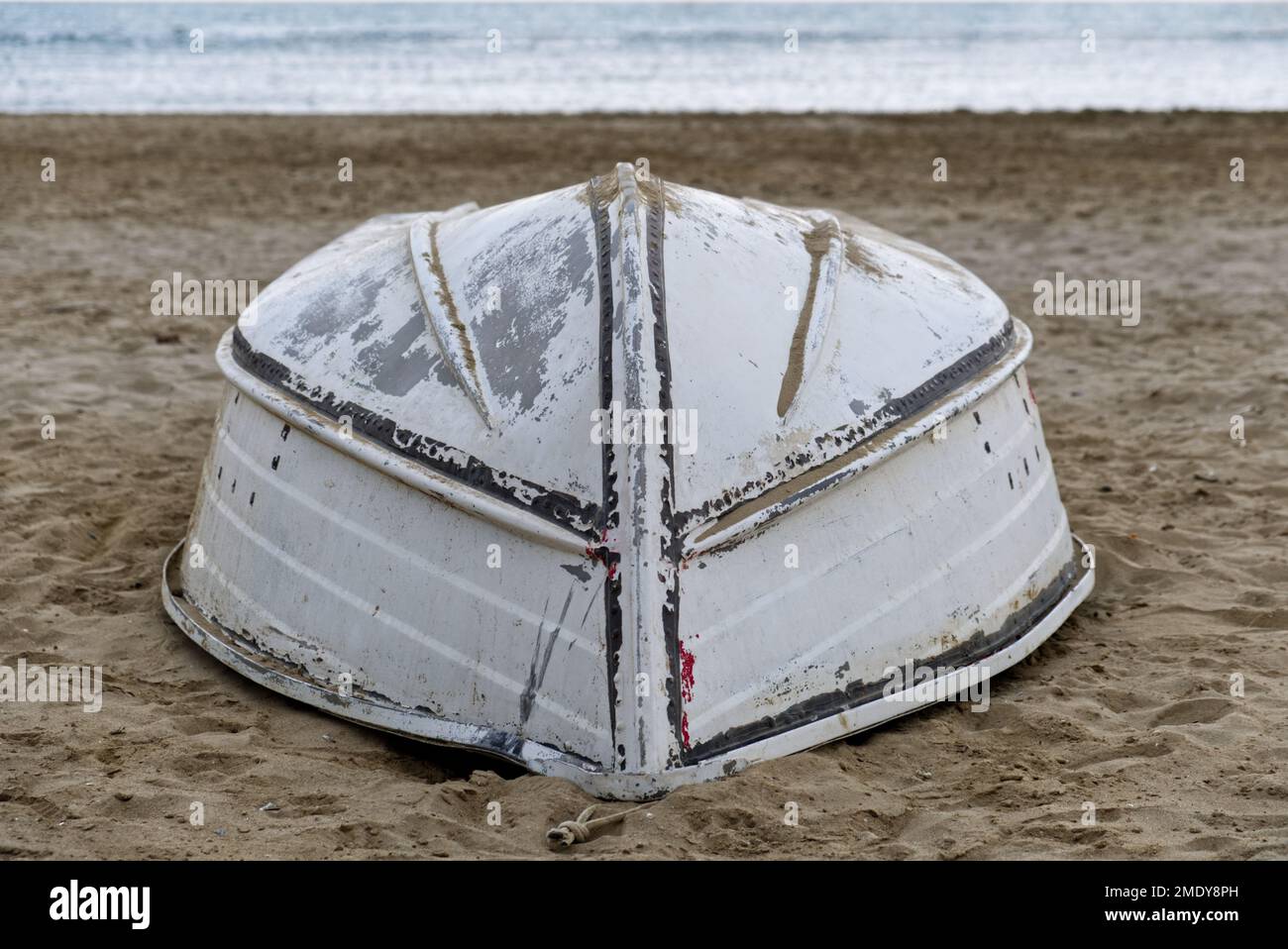 the keel of a small boat capsized on the beach Stock Photo - Alamy