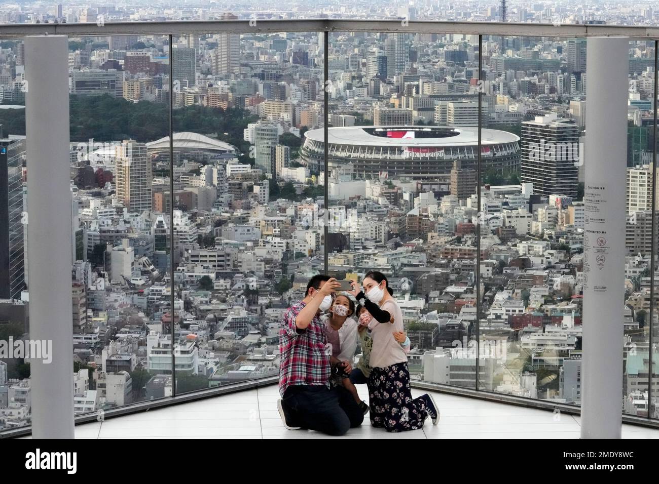 FILE - In this Aug. 7, 2021, file photo, a family takes pictures with ...