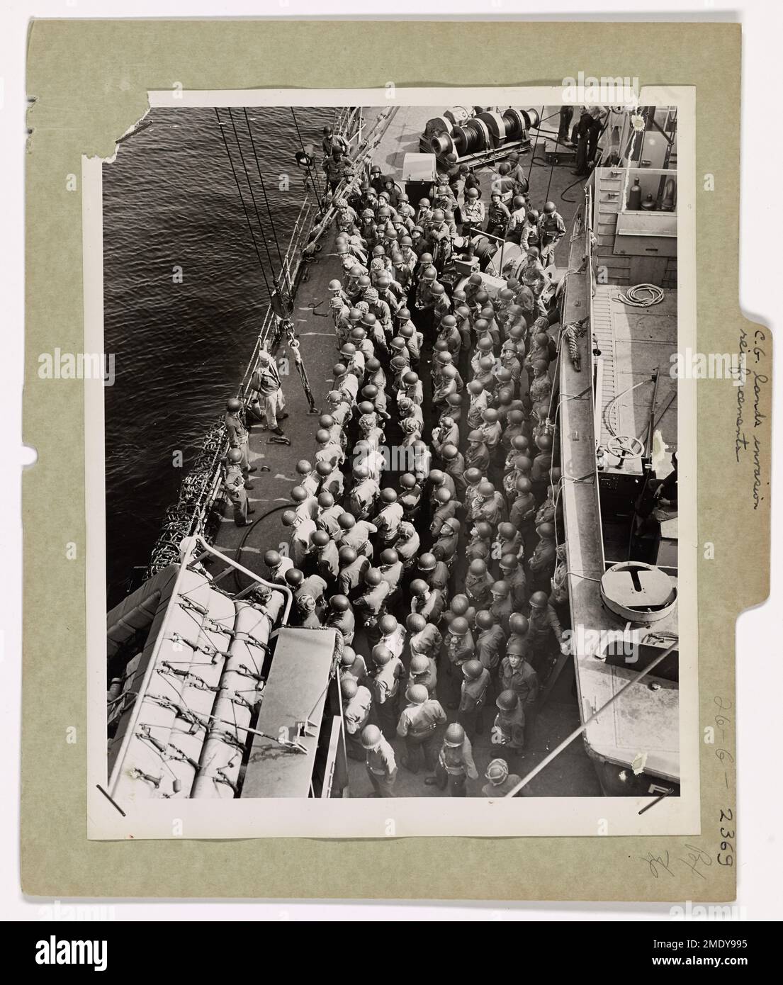 Coast Guard Lands Invasion Reinforcements. Army troops line up on the ...