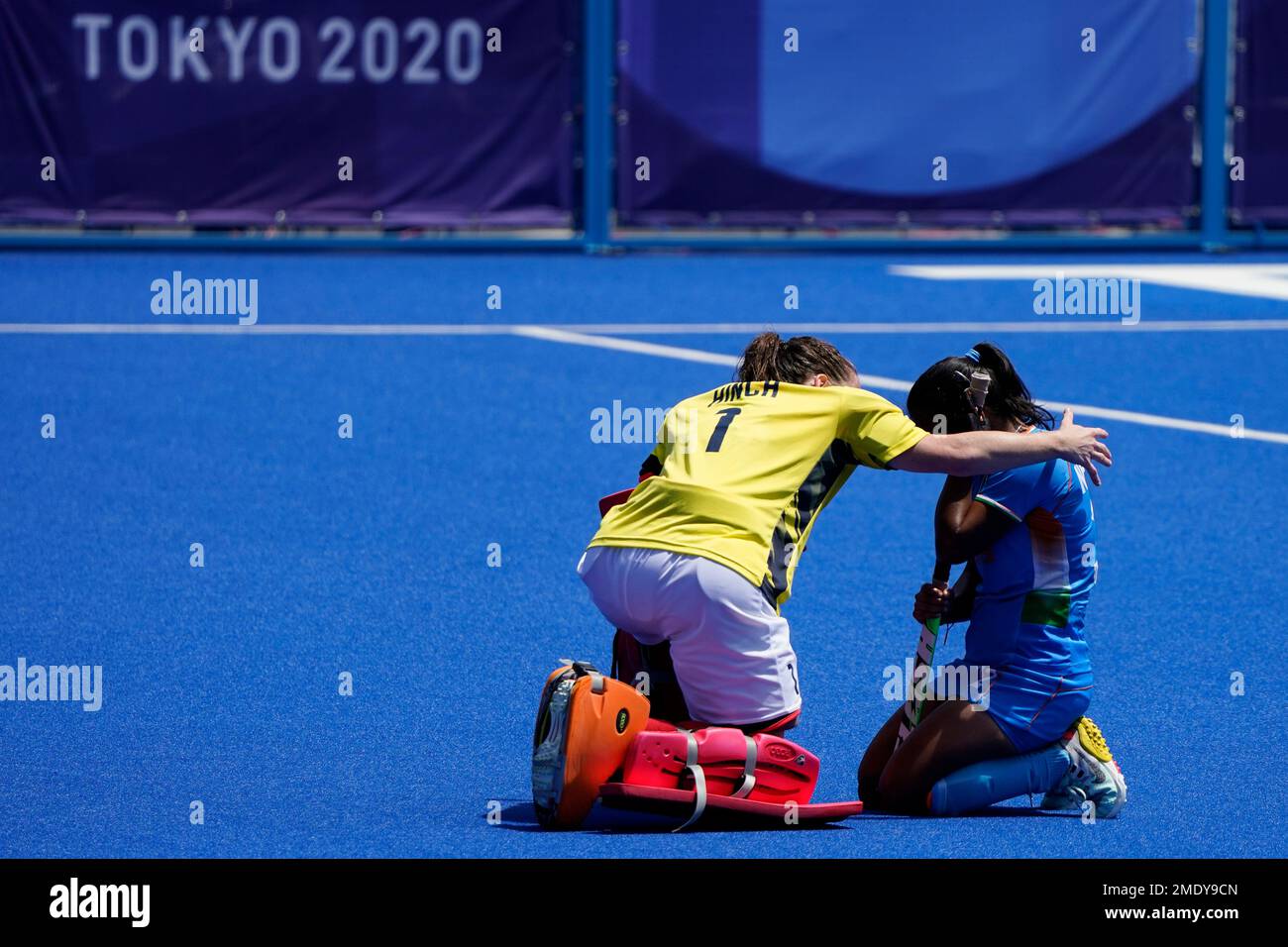 Britain's goalkeeper Claire Hinch (1) comforts India's Neha Neha, right ...