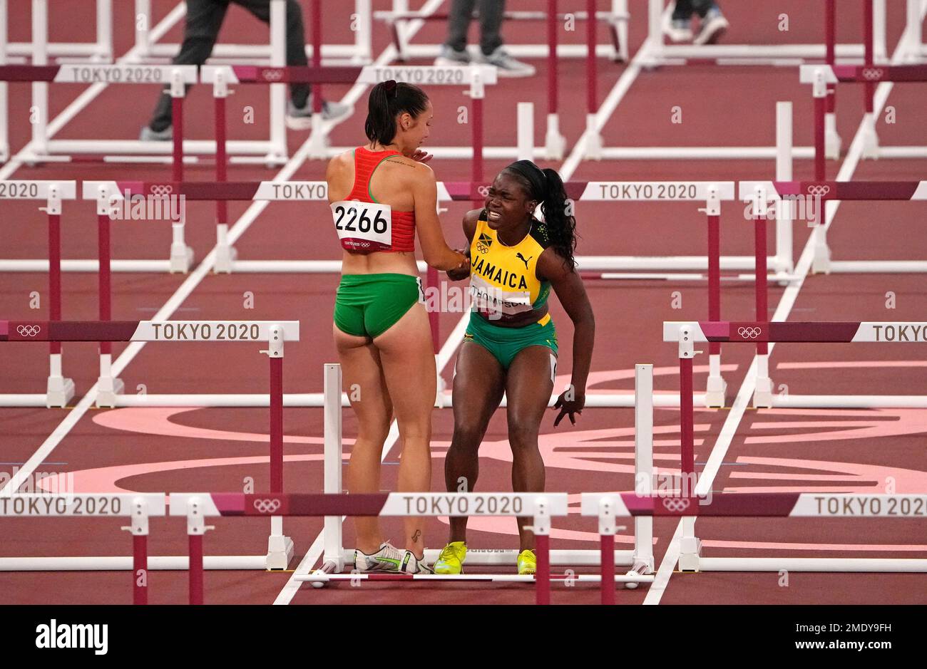 Luca Kozak, of Hungary, left, helps Yanique Thompson, of Jamaica ...