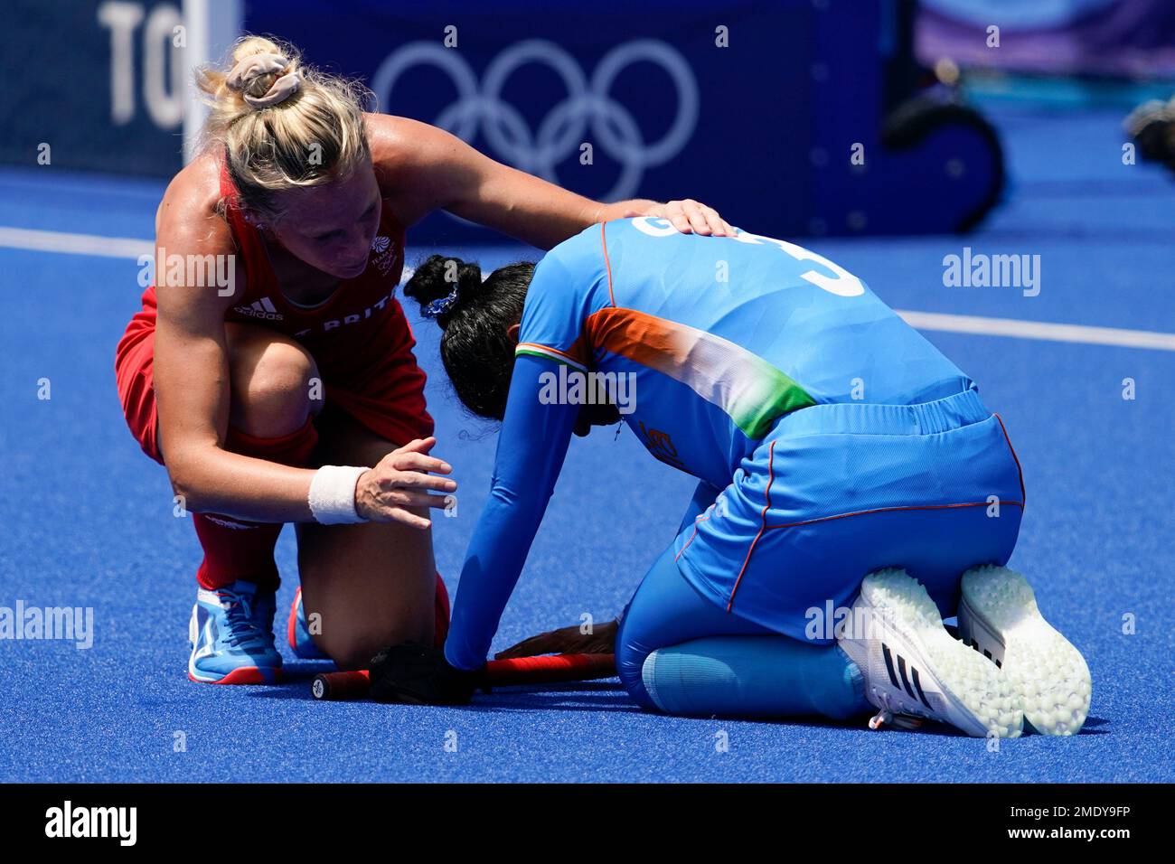Britain's Leah Julia Wilkinson, left, comforts India's Deep Grace Ekka ...
