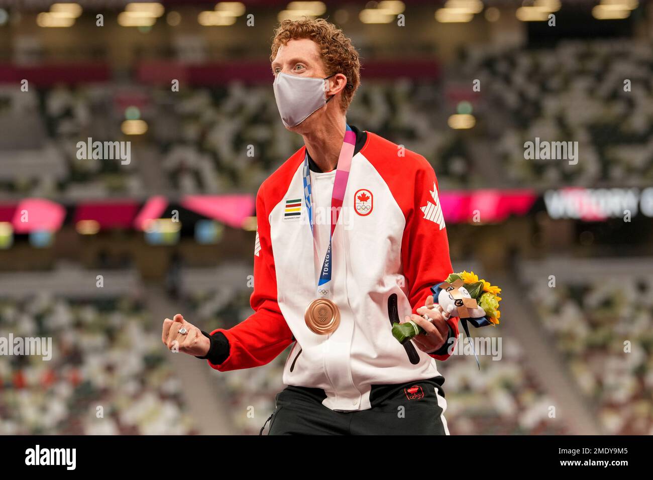 Bronze medalist Evan Dunfee, of Canada, poses during the medal ceremony ...