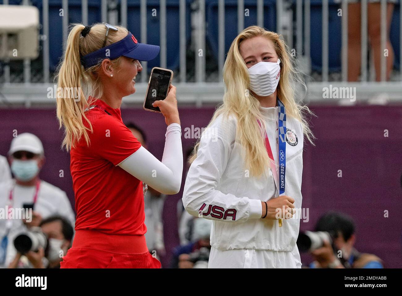 Jessica Korda, of the United States, left, films her sister Nelly Korda ...
