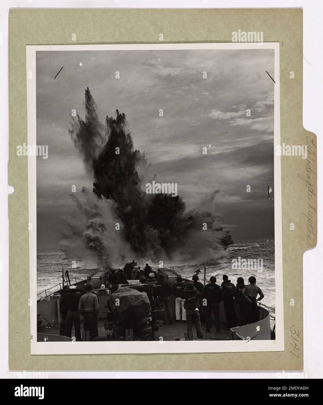 U.S. Coast Guardsmen watch as a depth charge explodes in the Atlantic ...