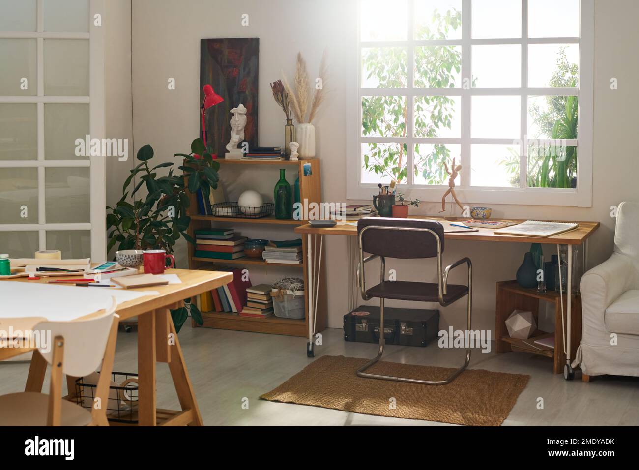 Part of living room in modern apartment serving as studio of art for ...
