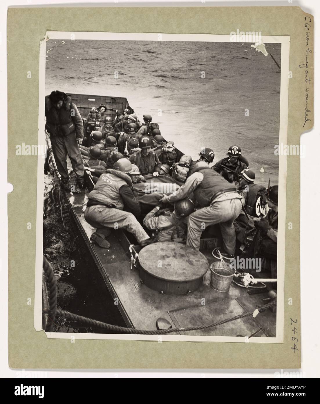 This image depicts a Coast Guard coxswain, wounded by Nazi machine gun ...