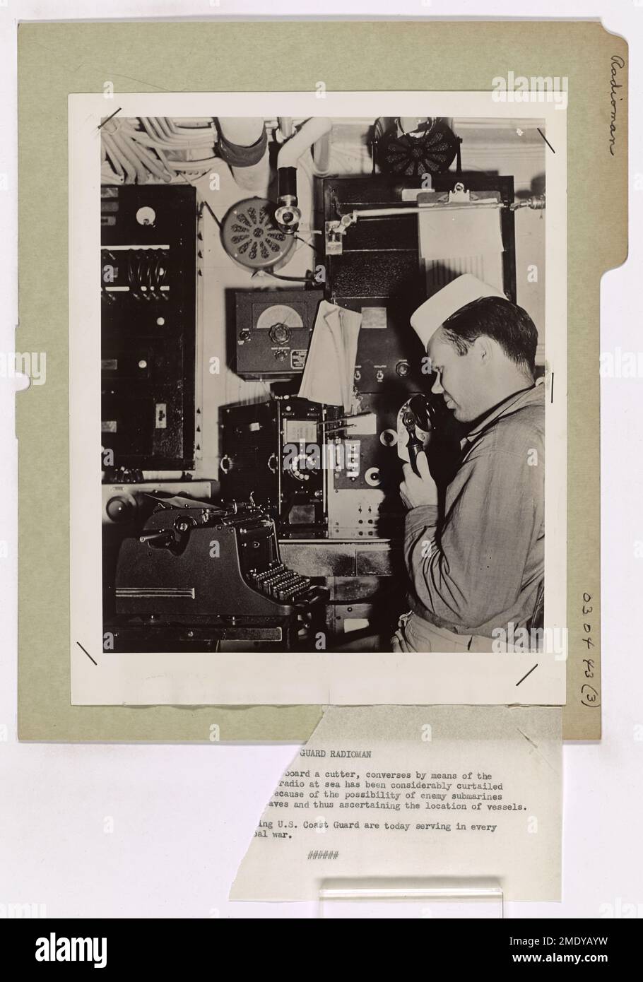 A Coast Guard radioman aboard a cutter uses a radio telephone for ...