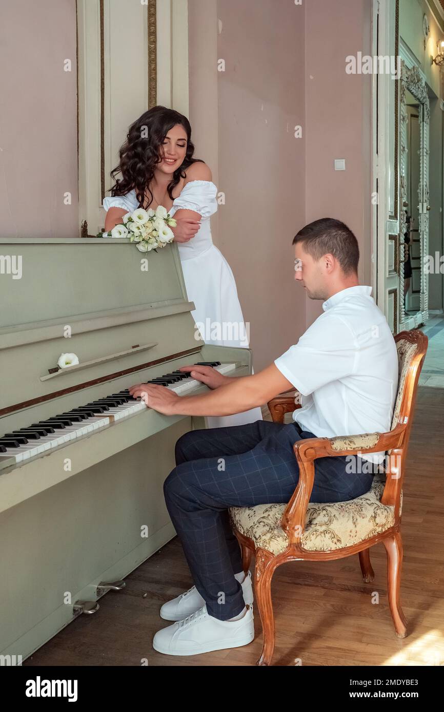 The groom plays on the piano. Grand piano wedding bride and groom music ...