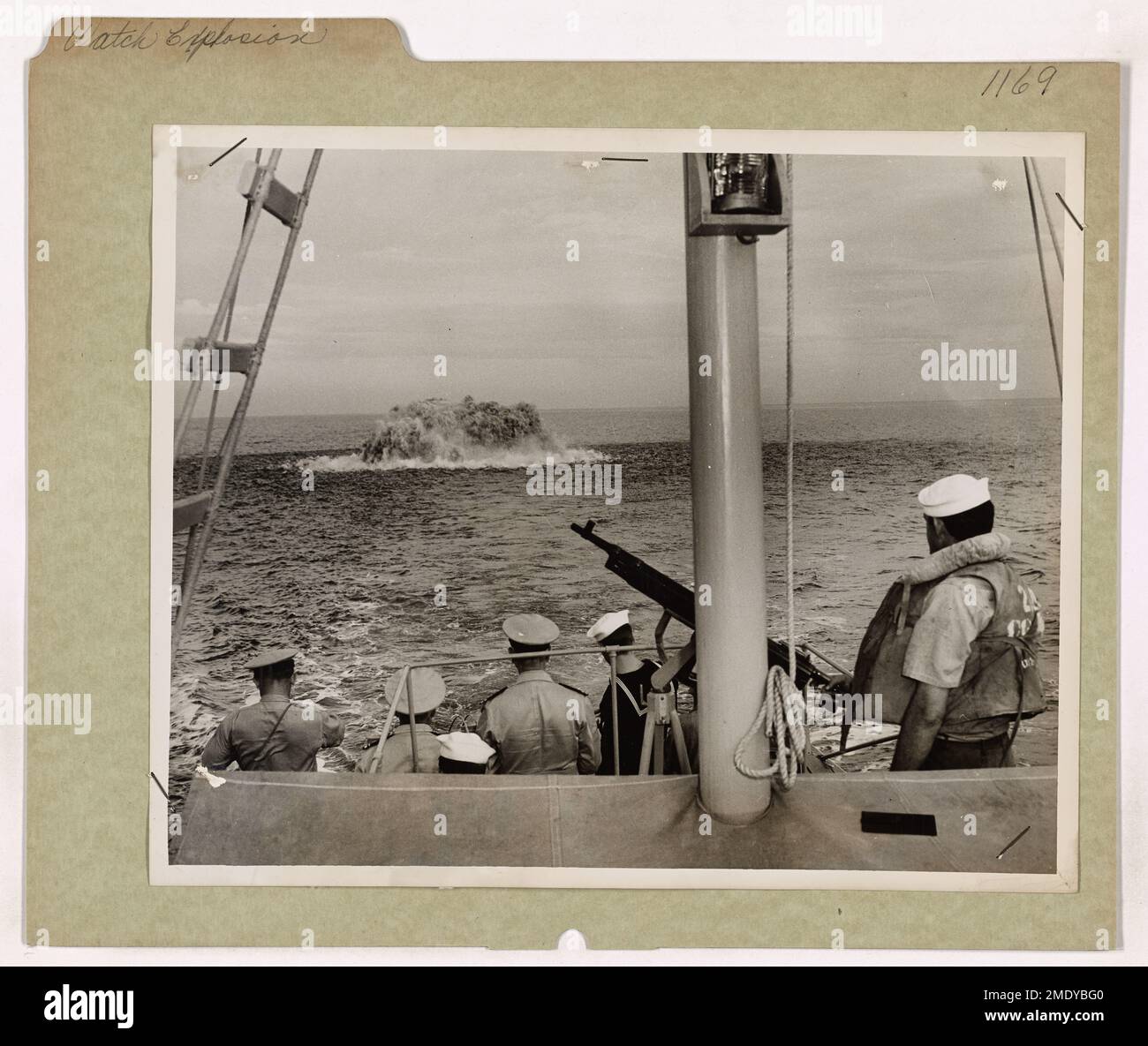 U.S. Coast Guard officers and crew watch as a depth charge explodes ...
