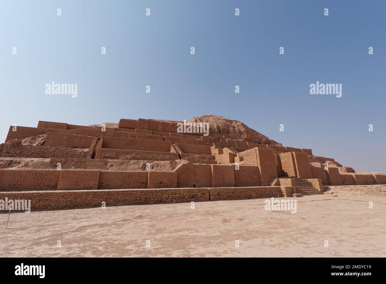 A beautiful shot of the historic Ziggurat of Chogha Zanbil under a blue ...